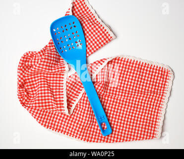 Red and white kitchen towel lies on wooden table. Texture of painted ...