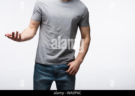 partial view of man showing shrug gesture isolated on grey background ...