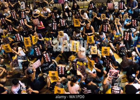 Protesters hold placards while chanting slogans during the ...
