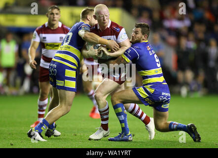 Wigan Warriors' Mike Cooper (right) is tackled by Hull Kingston Rovers ...