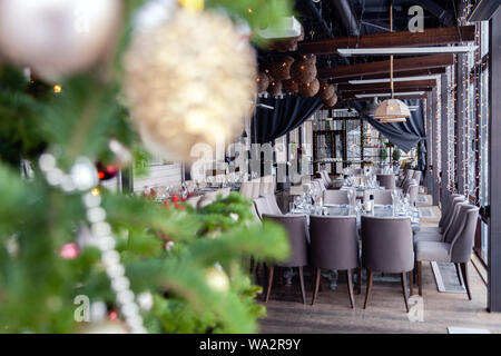 Modern veranda restaurant interior, banquet setting, glasses, plates ...