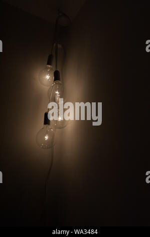 Modern lamp hanging down from ceiling in the dark background ...