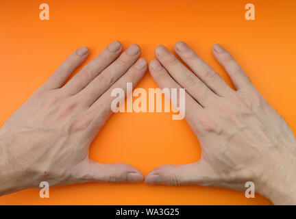 Hands showing the triangle sign Stock Photo - Alamy