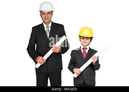 Boy imitating as architect and standing with his father Stock Photo - Alamy