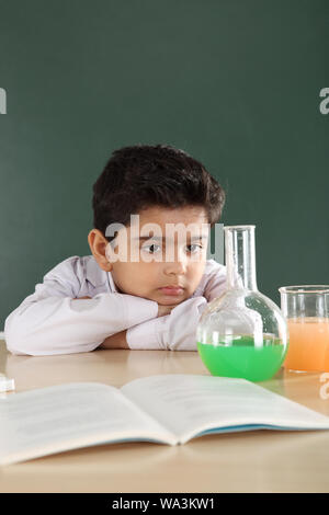 Schoolboy looking sad in a chemistry lab Stock Photo - Alamy