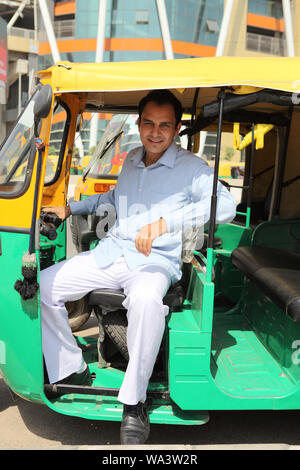 Auto driver sitting in an auto rickshaw and showing thumbs up sign ...