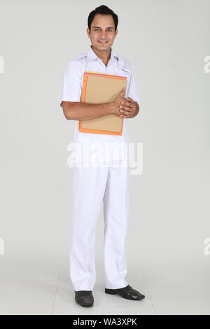 Peon holding files in office Stock Photo - Alamy