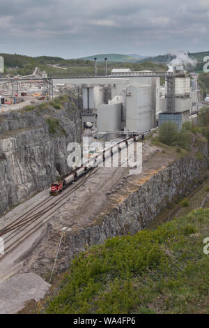 Tunstead quarry Derbyshire. A Hunslet industrial shunter taking hoppers ...