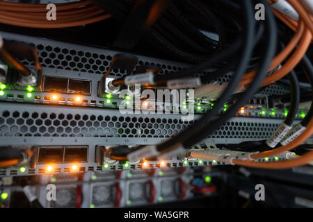 Fiber optical switch with connected FC cables in server room. Cross ...