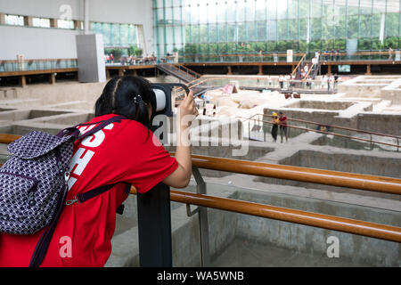 Asian Woman looking through virtual reality device at home. Augmented ...