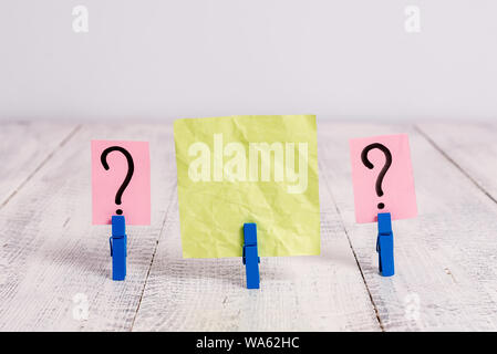 Scribbled and crumbling sheet with paper clips placed on the wooden ...