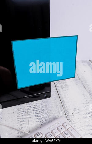 Notation paper taped to black computer monitor screen near white ...