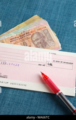 Indian rupees with a cheque book Stock Photo - Alamy