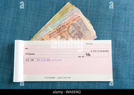 Indian rupees with a cheque book Stock Photo - Alamy