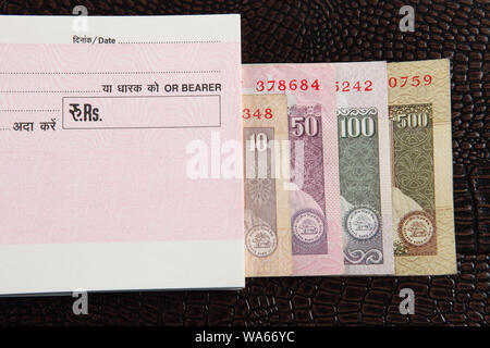 Indian rupees with a cheque book Stock Photo - Alamy