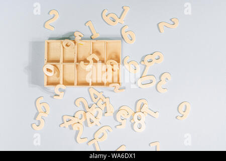 some wooden numbers to be ordered in a small wooden box Stock Photo - Alamy