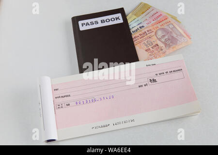Indian rupees with a cheque book Stock Photo - Alamy