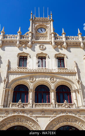 People in front of the Neo-Manueline style facade of Rossio railway ...