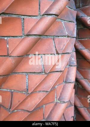 Tudor twisted barley sugar chimney pot on chimney stack with flint, red ...