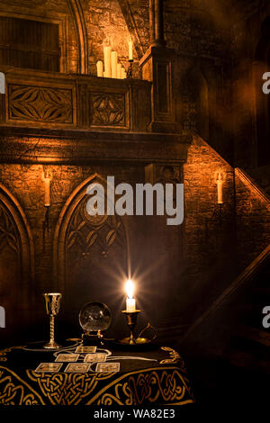 Tarot reading with tarot card background and candlelight on the table ...