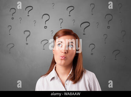 Person with question marks around face Stock Photo - Alamy