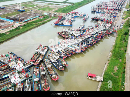 Aerial view of fishing boats coming together at Qingyu fishing port at ...
