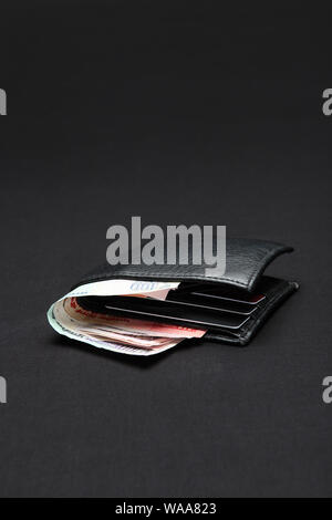 Selective focus of a money inside a wallet on wooden background Stock ...