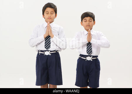 School children praying with hands joined together Stock Photo - Alamy