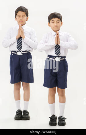 School children praying with hands joined together Stock Photo - Alamy