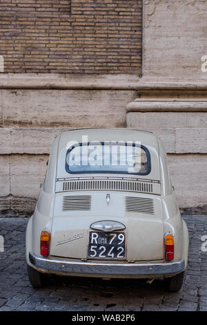 Beige coloured vintage Fiat 500 classic car parked in front of a house ...