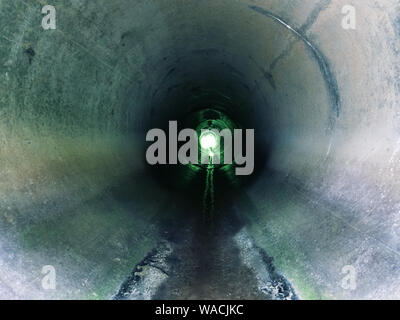 Drainage pipe under highway (culvert). Filming inside pipe Stock Photo ...