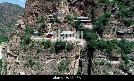 A total of 28 ancient Taoist temples built on the cliff are seen in ...