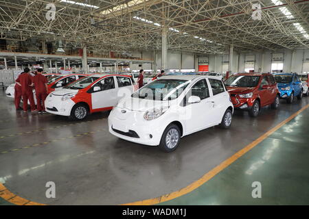 --FILE--Chinese workers assemble electric vehicles (EVs) on the ...
