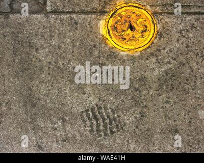 Gas inspection cover and footprint Stock Photo - Alamy
