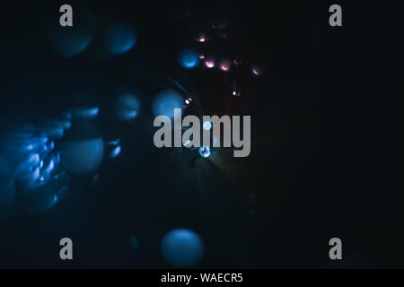 Beautiful optical blue cold bokeh on a dark background Stock Photo - Alamy