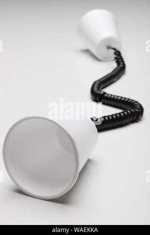 Tin can phone with wired cable Stock Photo - Alamy
