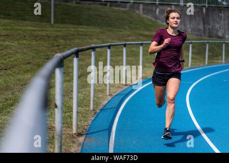 Athletics, woman sprinting in the curve, Germany Stock Photo - Alamy