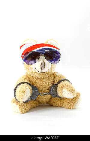 Plush teddy bear with handcuffs on white background Stock Photo - Alamy