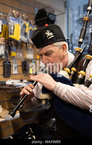 Impromptu playing his bagpipe Edinburgh piper Alastair Wilkinson inside ...