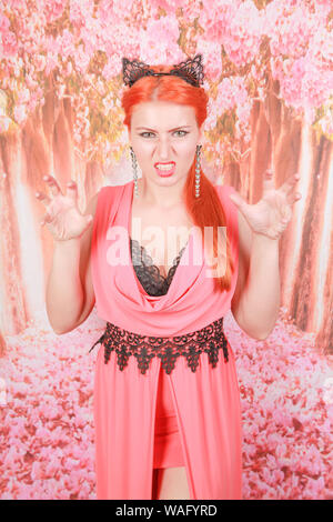 pretty woman in trendy coral color red evening dress Stock Photo - Alamy