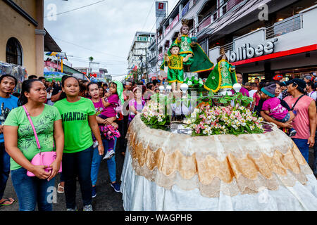 A Procession Of Floats With Santo Nino Statues Take Part In A Street ...