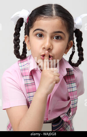 Elementary Student with Finger on Lips Stock Photo - Alamy