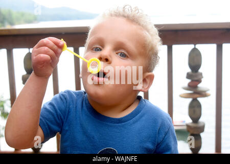 3 year old boy blowing bubbles Stock Photo - Alamy