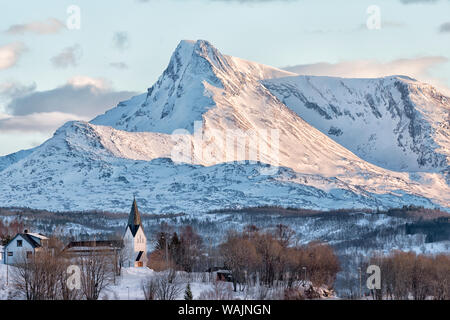 Norway, Evenes. View of Evenes from across the fjord in evening light ...