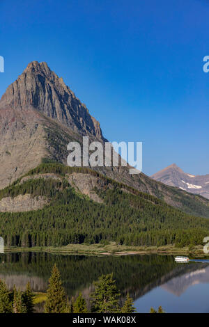 Tour boat on Swiftcurrent Lake in Glacier National Park, Montana, USA ...
