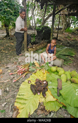 Kosrae, Micronesia (FSM). Local Kosrae man at a traditional pit oven ...