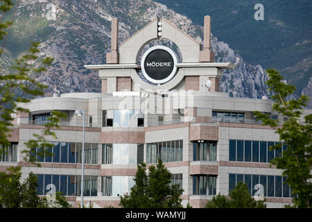 A logo sign outside of the headquarters of Modere in Springville, Utah ...