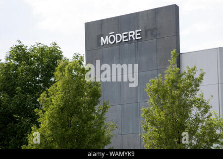 A logo sign outside of the headquarters of Modere in Springville, Utah ...
