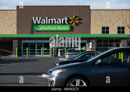 A logo sign outside of a Walmart Neighborhood Market retail store ...