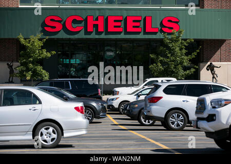 A logo sign outside of a SCHEELS retail store location in Sandy, Utah ...